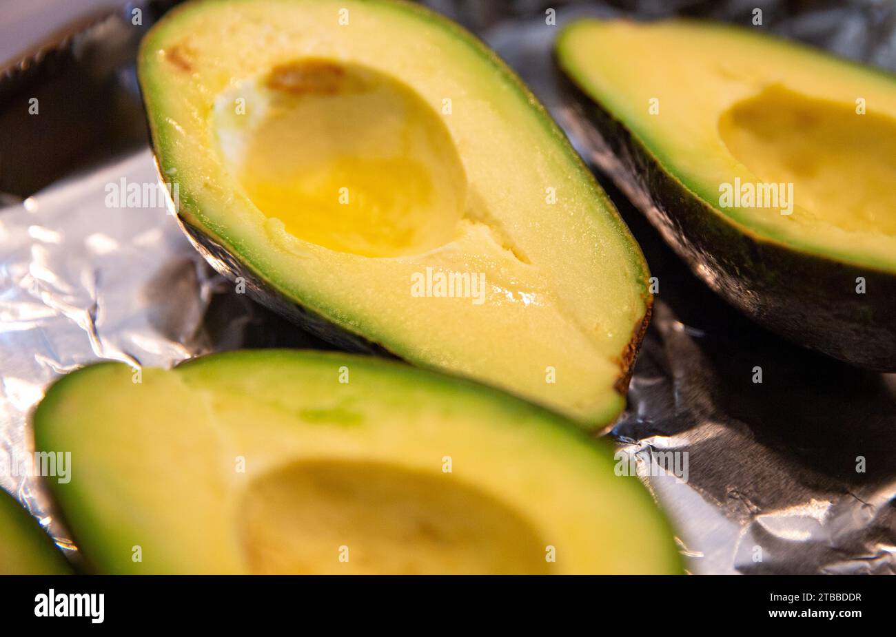 Avocados cut in halves hi-res stock photography and images - Alamy