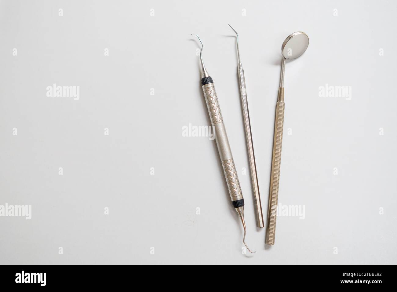 Dental tools, mirror, explorer, hook on the white background with copy ...