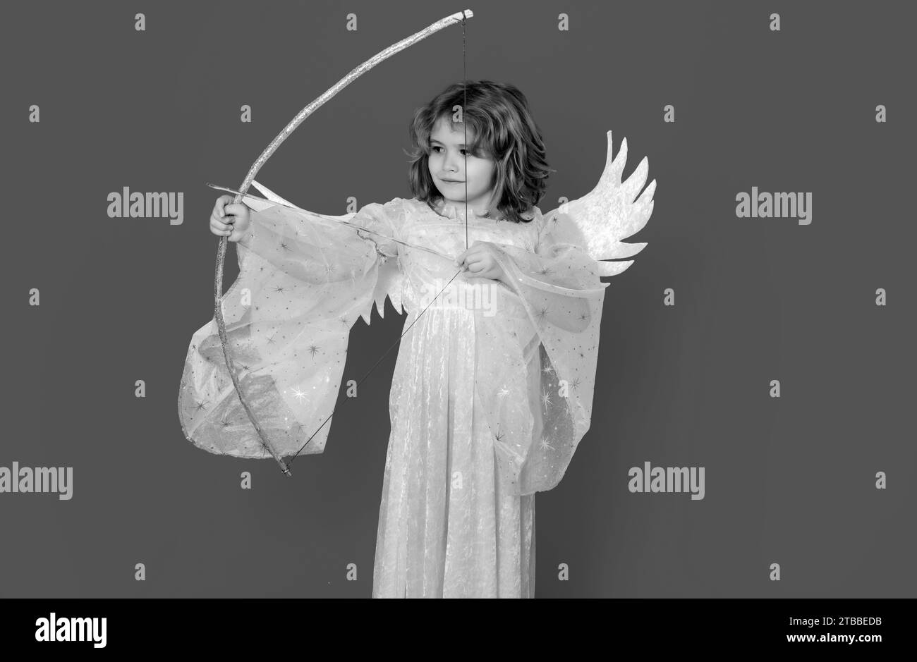 Angel kid shoots a love arrow from a bow on Valentines Day. Valentines ...