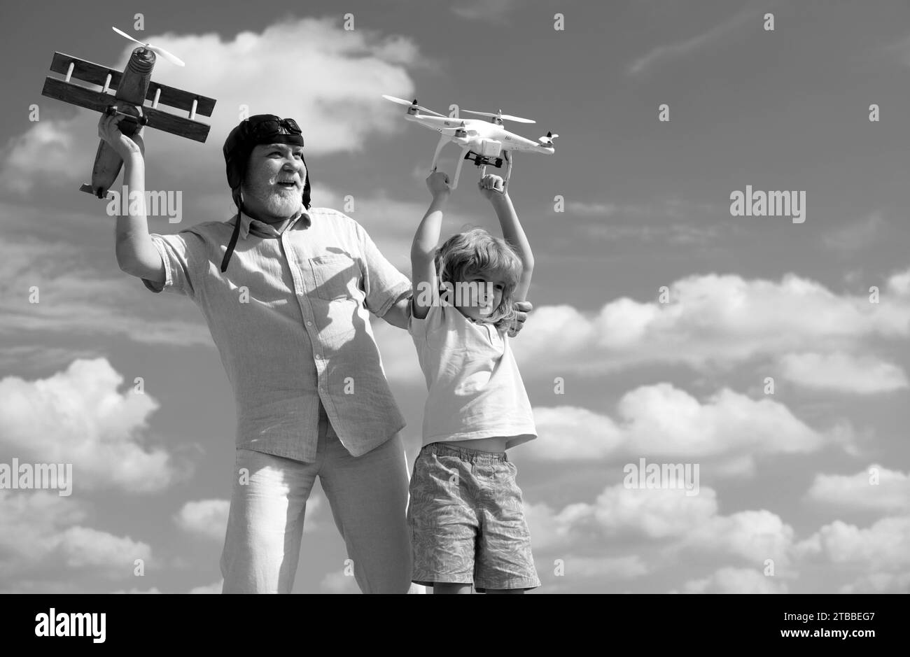 Grandfather and grandson hold plane and drone quadcopter. Child boy ...