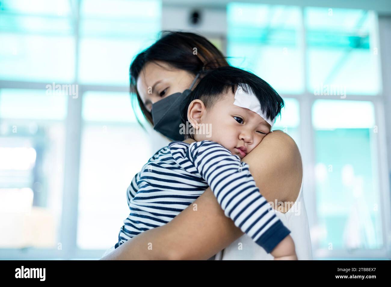Photo of mother carrying her baby sick in hospital. Loving mom carrying ... Photo of mother carrying her baby sick in hospital. Loving mom carrying ...