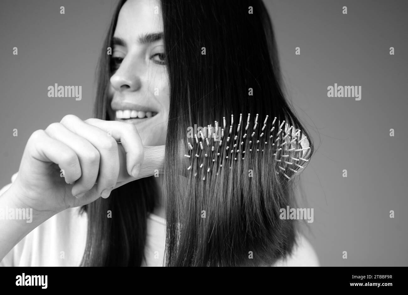 Close up woman combing hair. Hair Care. Beautiful brunette woman ...
