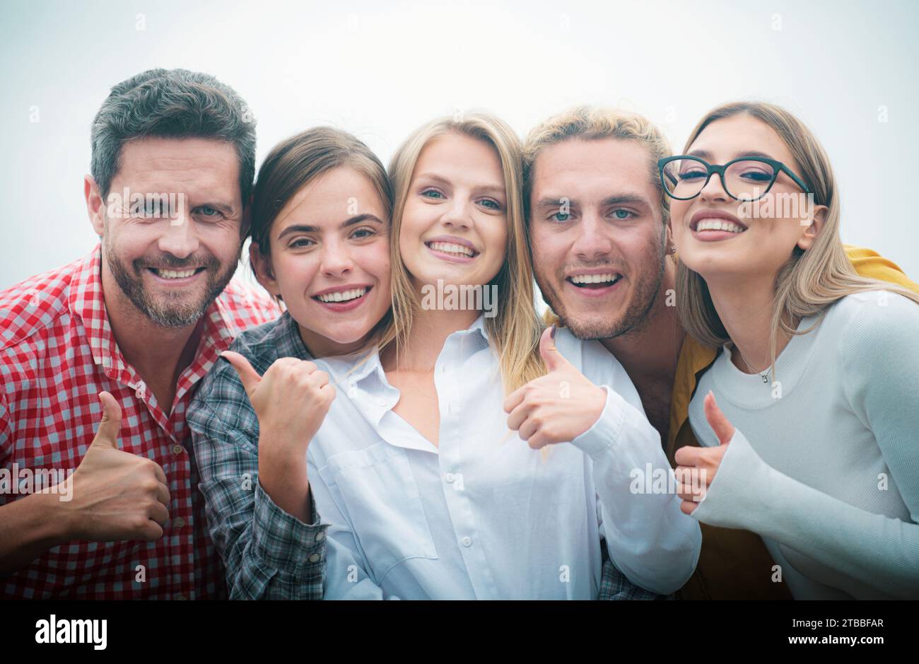 Smiling group of friends laughing with thumb up. Happy company students ...