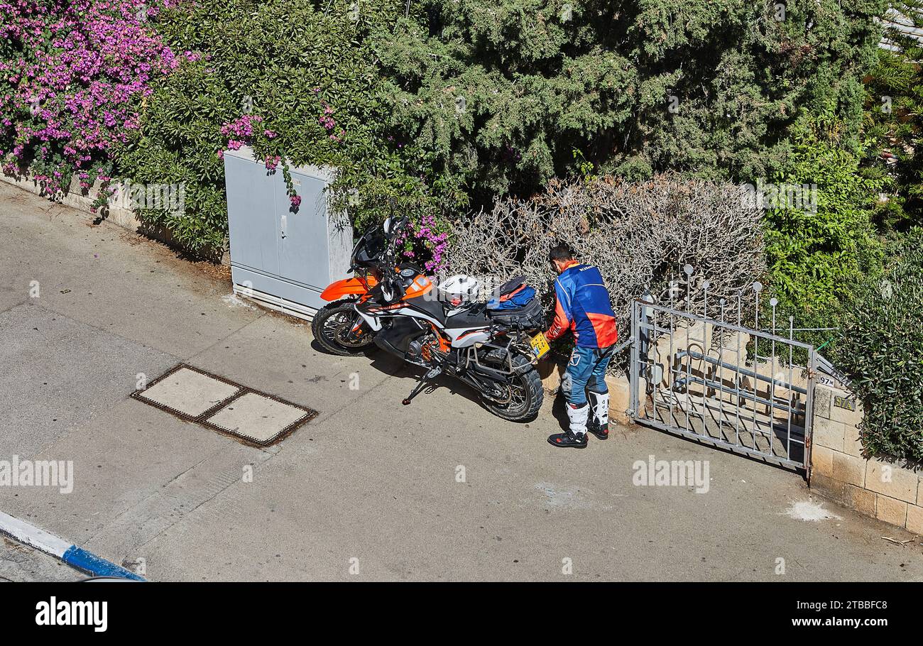 Haifa, Israel - October 22, 2023: A person in a motorcycle suit riding ...