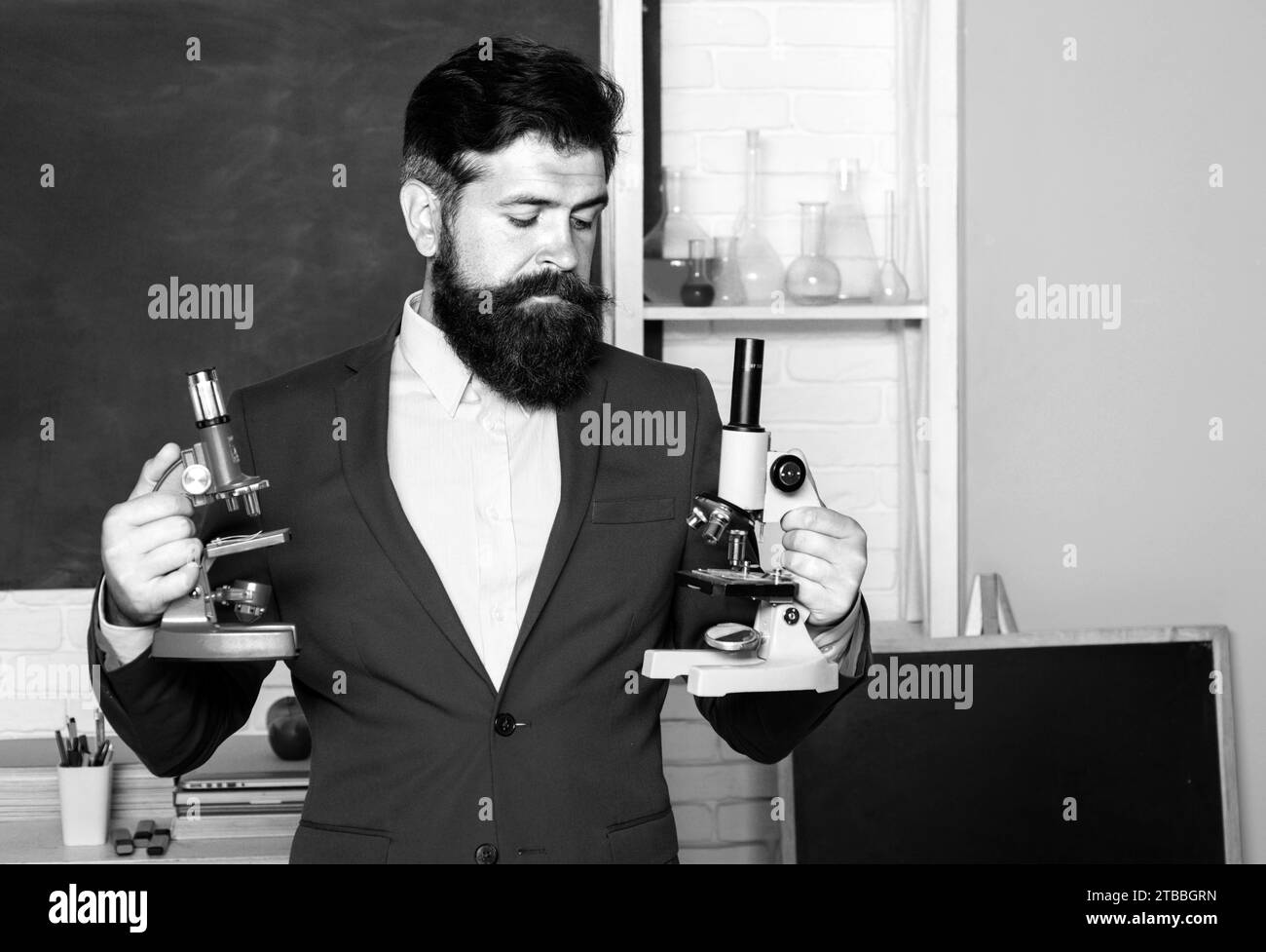 Portrait of thinking male teacher with microscope, professor, tutor ...