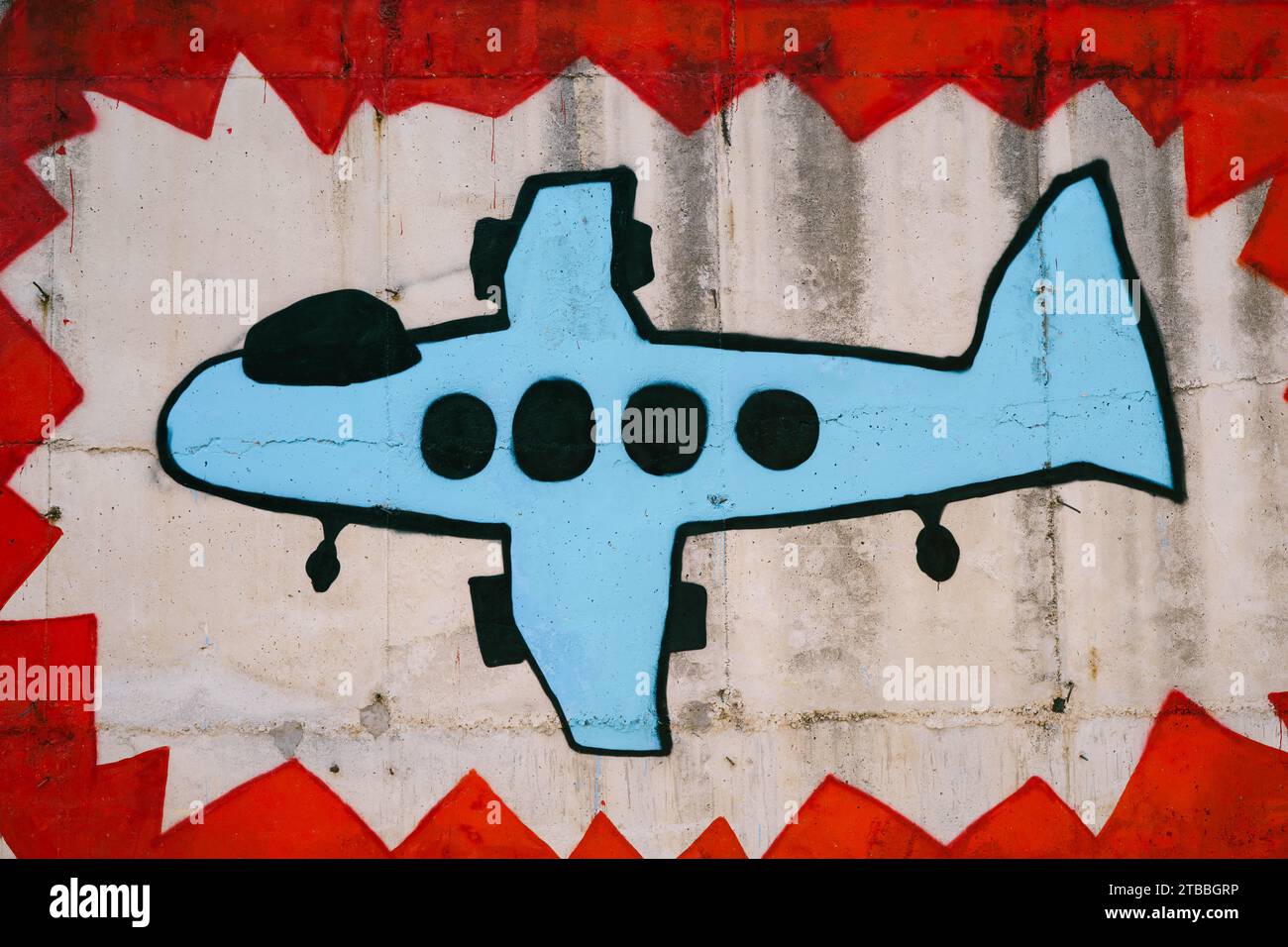 Graffiti in the form of a passenger plane on a concrete wall Stock ...