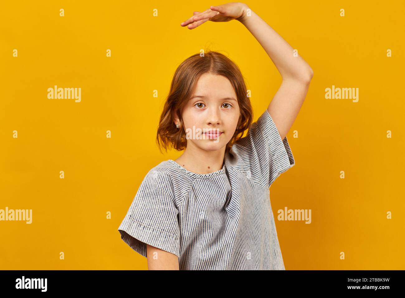 Happy teen girl dancing on yellow studio background Stock Photo - Alamy