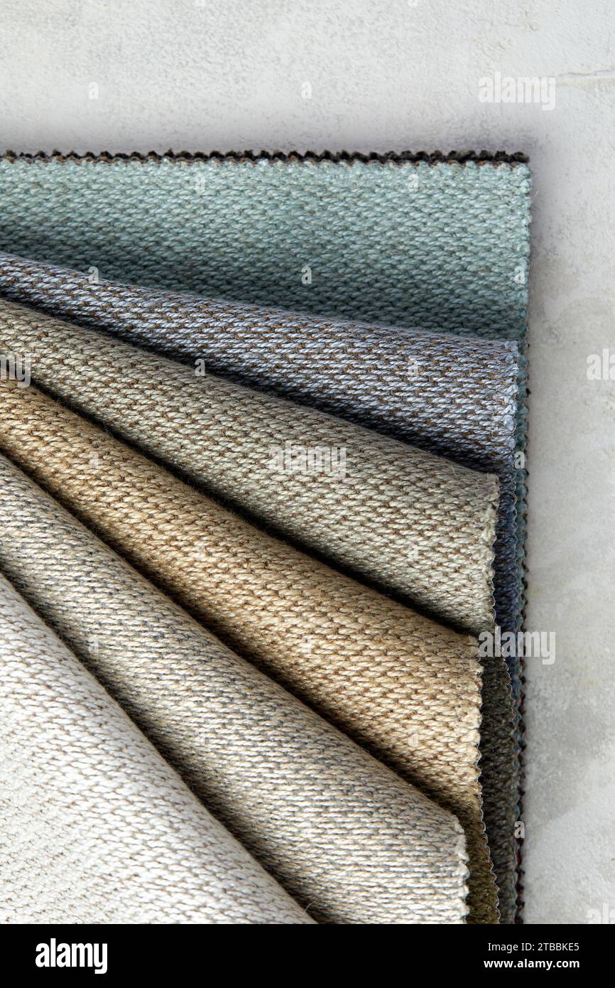 Fabric swatches in different colors are stacked for selection. A ...