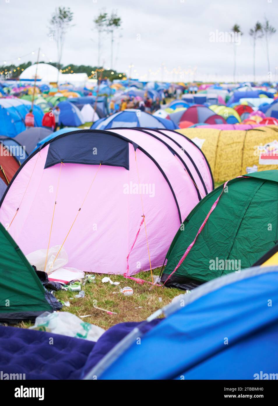 Tents, campsite and music festival on outdoor field or mess pollution ...