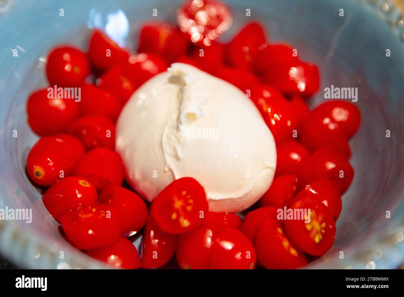 Fresh burrata with sliced cherry tomatoes Stock Photo - Alamy
