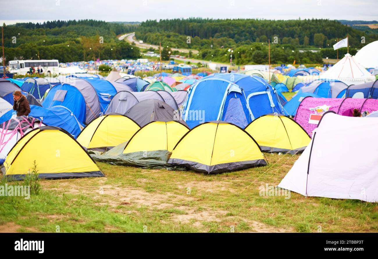 Tents, field and music festival outdoor for dancing event in forest for ...