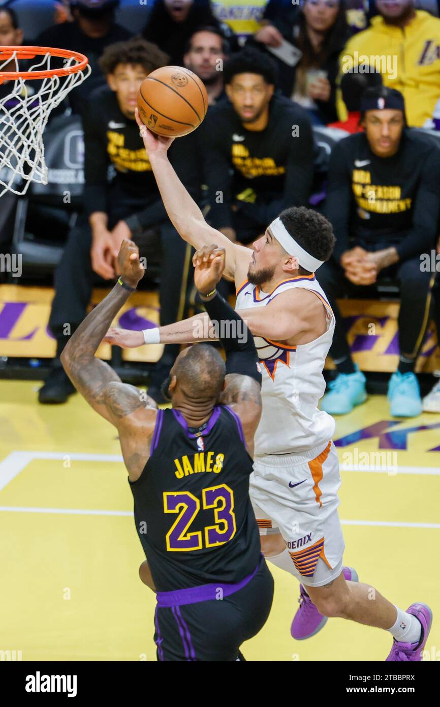 Los Angeles, USA. 5th Dec, 2023. Phoenix Suns' Devin Booker (R) drives to basket against Los ...