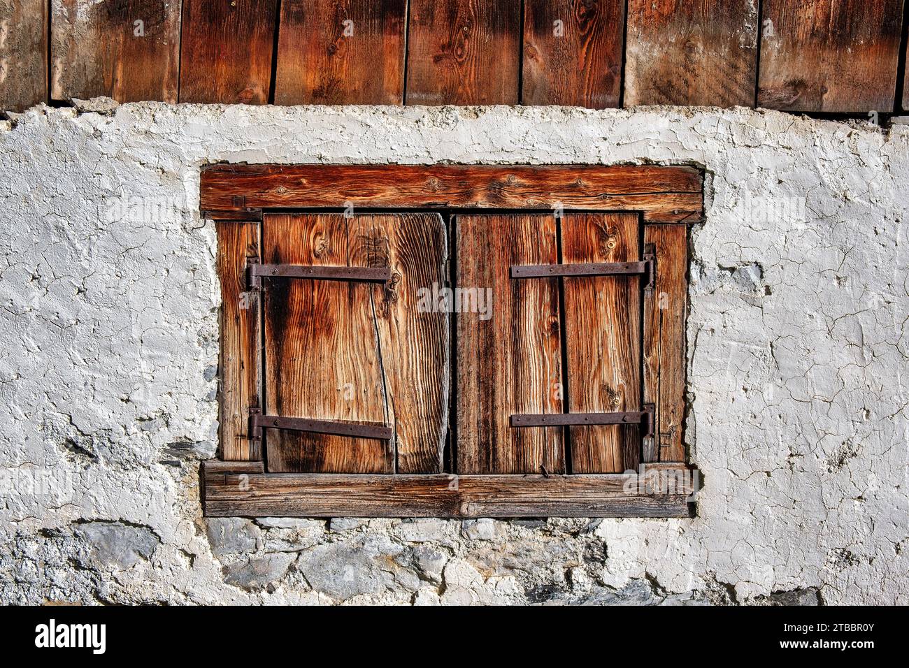 Traditional wooden window shutters of an old farm house in Switzerland ...
