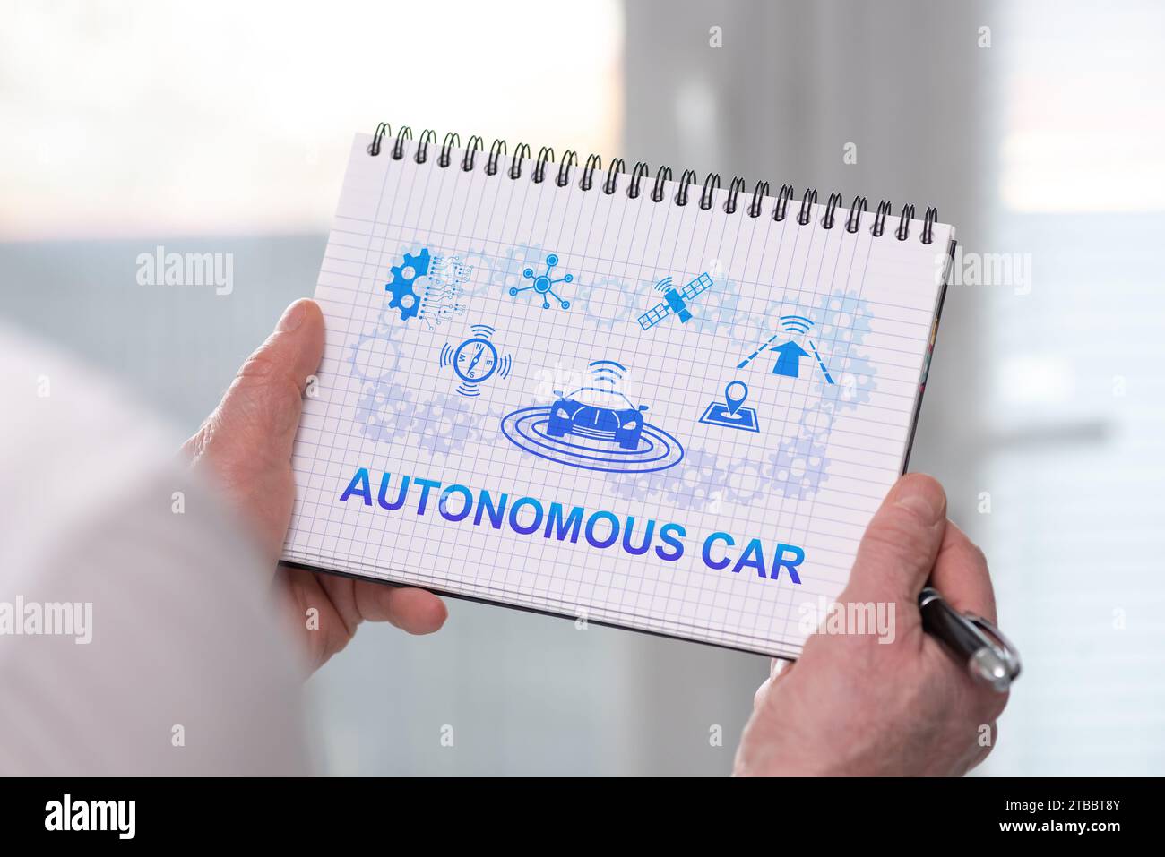 Hand holding a notepad with autonomous car concept Stock Photo - Alamy