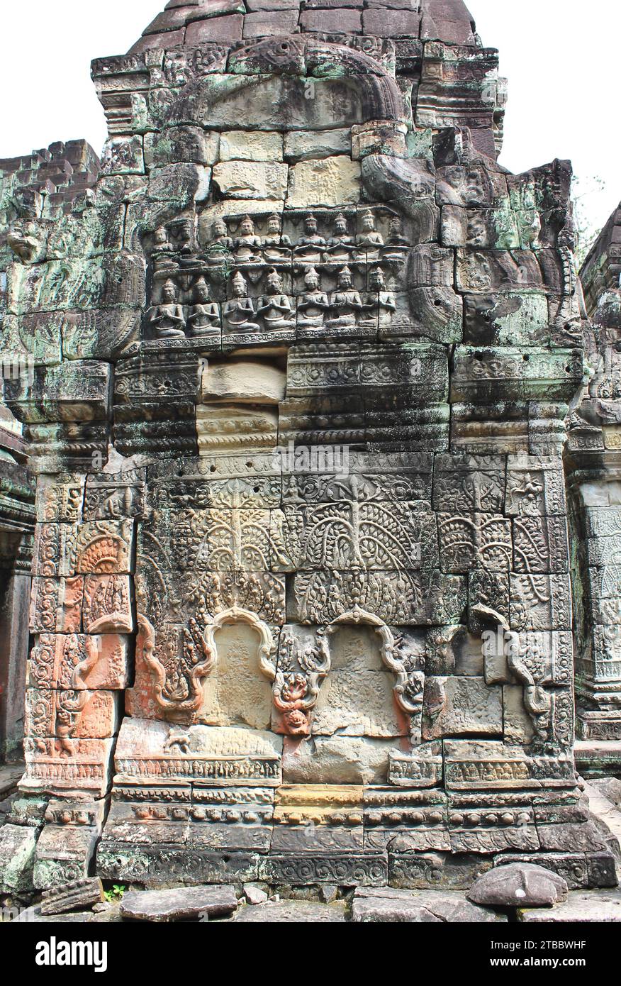 Restored ancient stone temple with ornate carved bas relief patterns ...