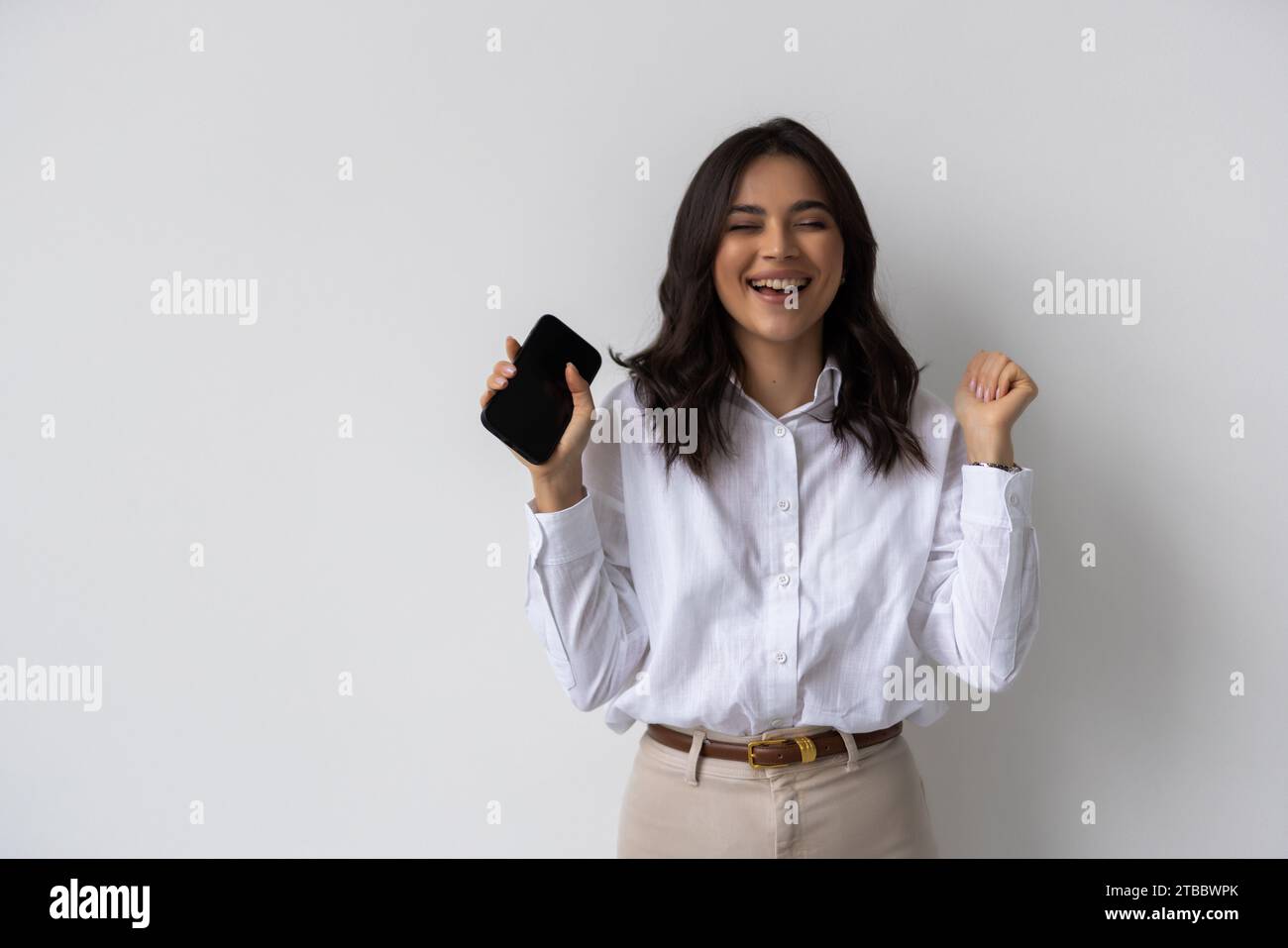 Enthusiastic woman winning on mobile phone, rejoicing and screaming of ...