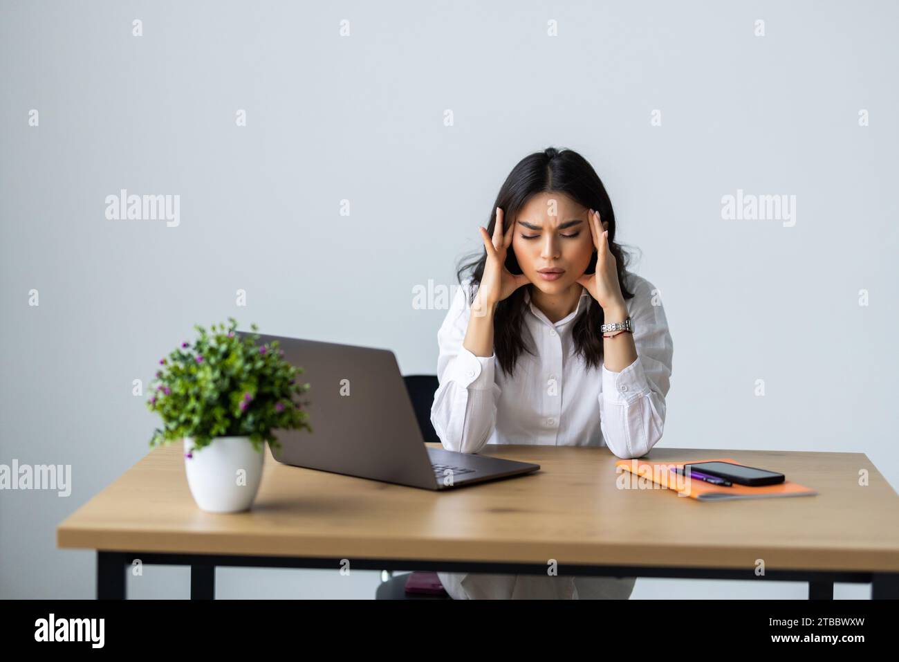 Worried fatigued mature business woman wearing glasses having headache ...