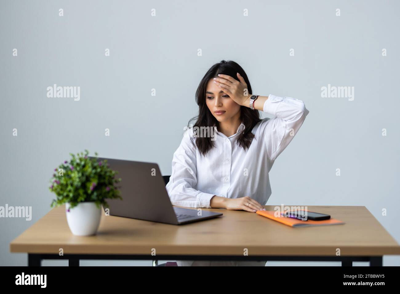 Worried fatigued mature business woman wearing glasses having headache ...