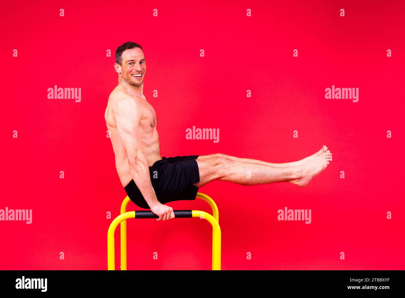 Male gymnast performing handstand on parallel bars, studio shot Stock ...