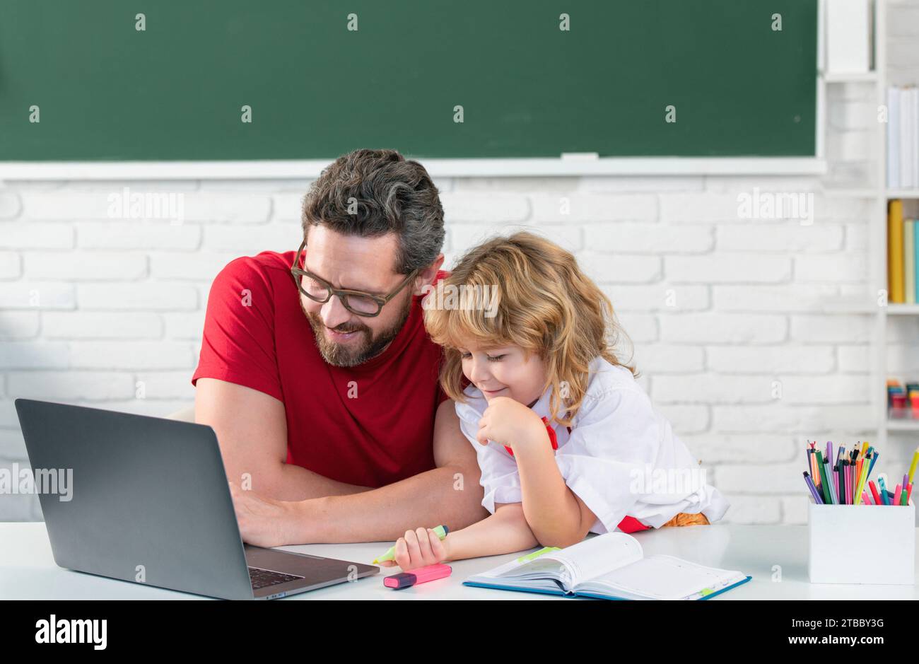 First day at school. Teacher helping child student pupil from ...