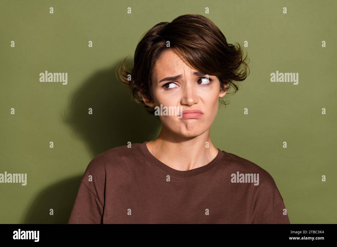 Photo of upset disappointed cute woman with bob hairdo dressed brown t ...