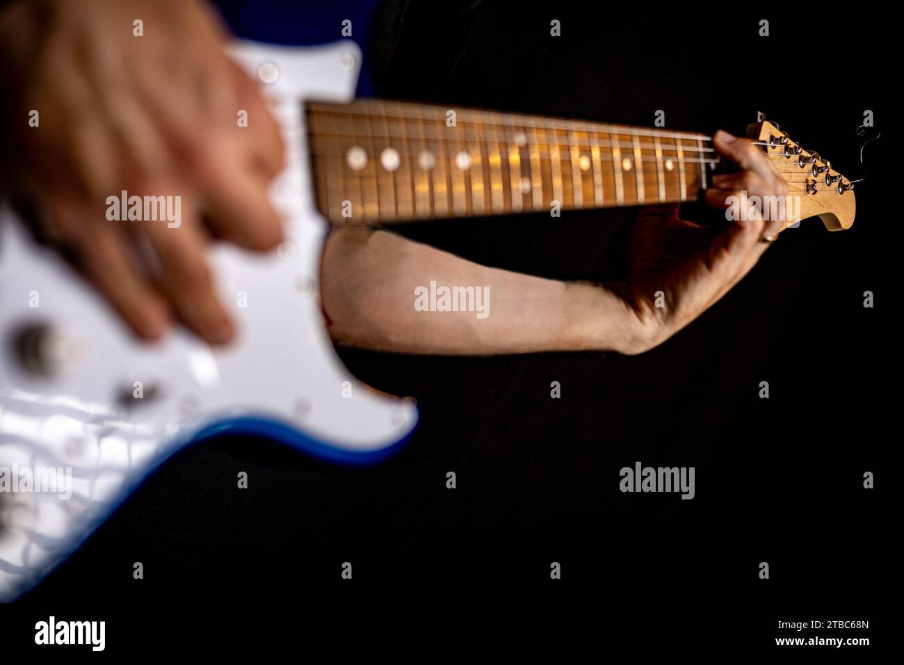 Musician playing guitar during acoustic concert Stock Photo - Alamy