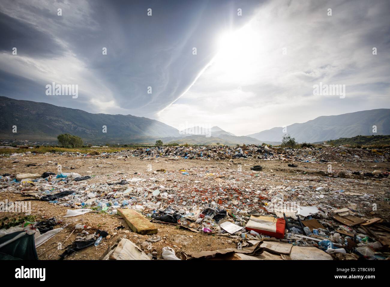 Polluted Landscape with Waste in Front of a Mountain Background - shot ...