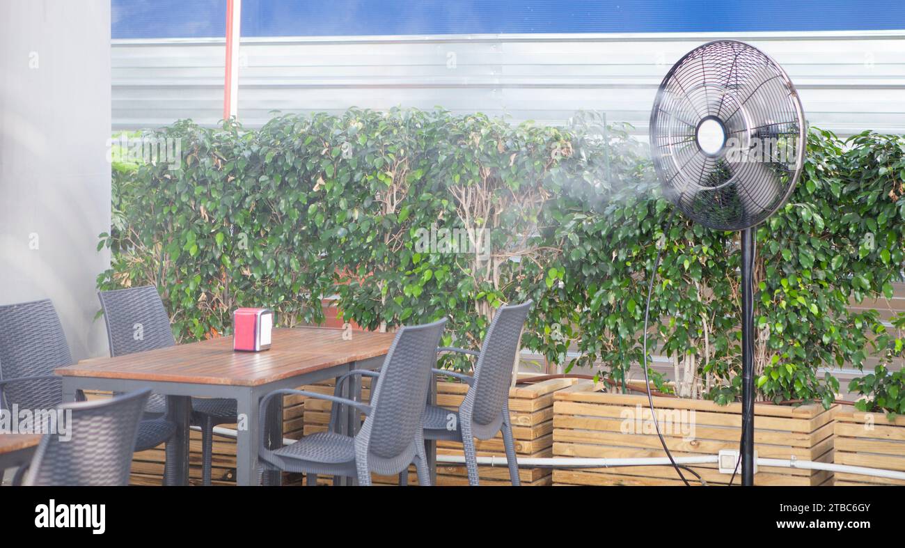Water Vapour Mist Fan splashing vaporized water at terrace restaurant ...