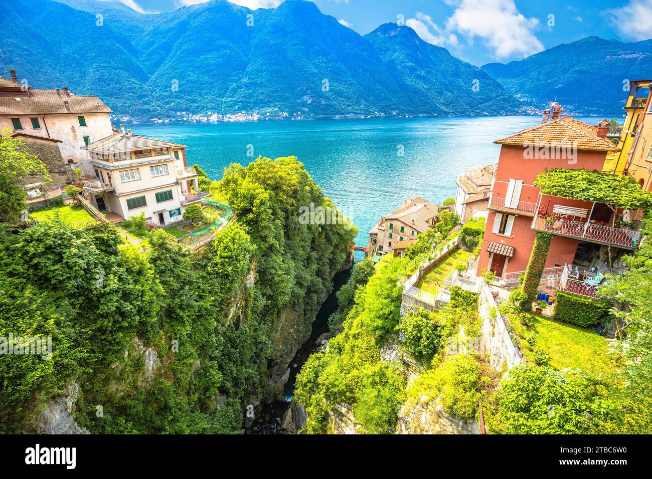 Town of Nesso on steep cliffs and creek waterfall gorge on Como Lake ...