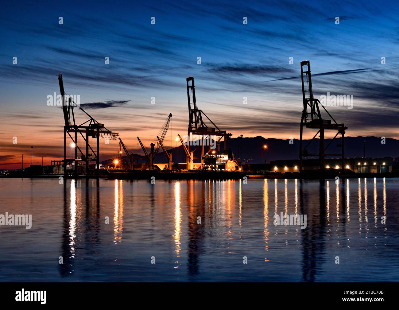 Blue hour by the industrial harbour of Malaga Stock Photo - Alamy