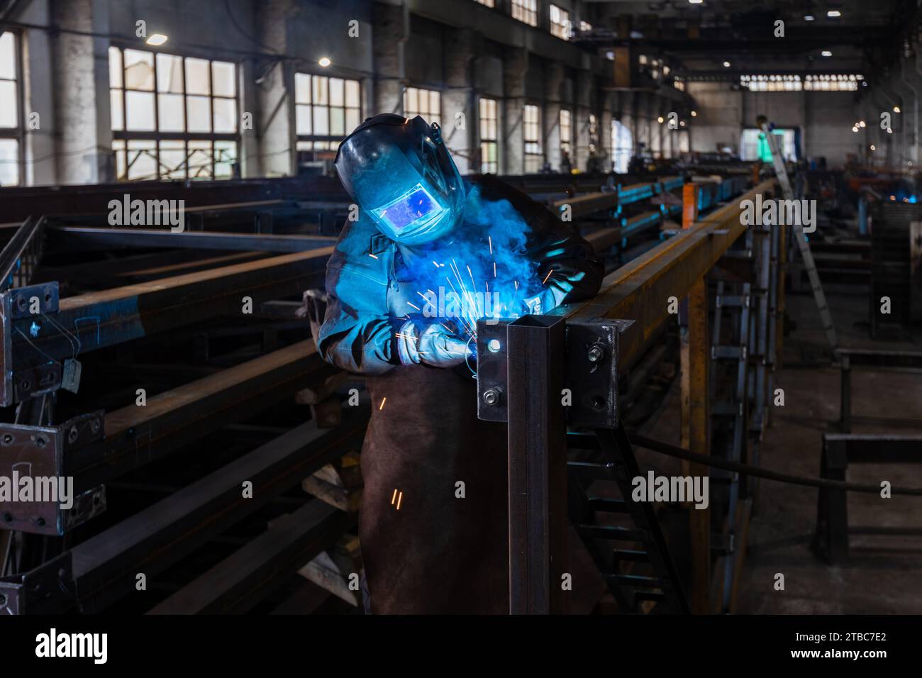 The welder works in the workshop. The moment of welding of metal ...