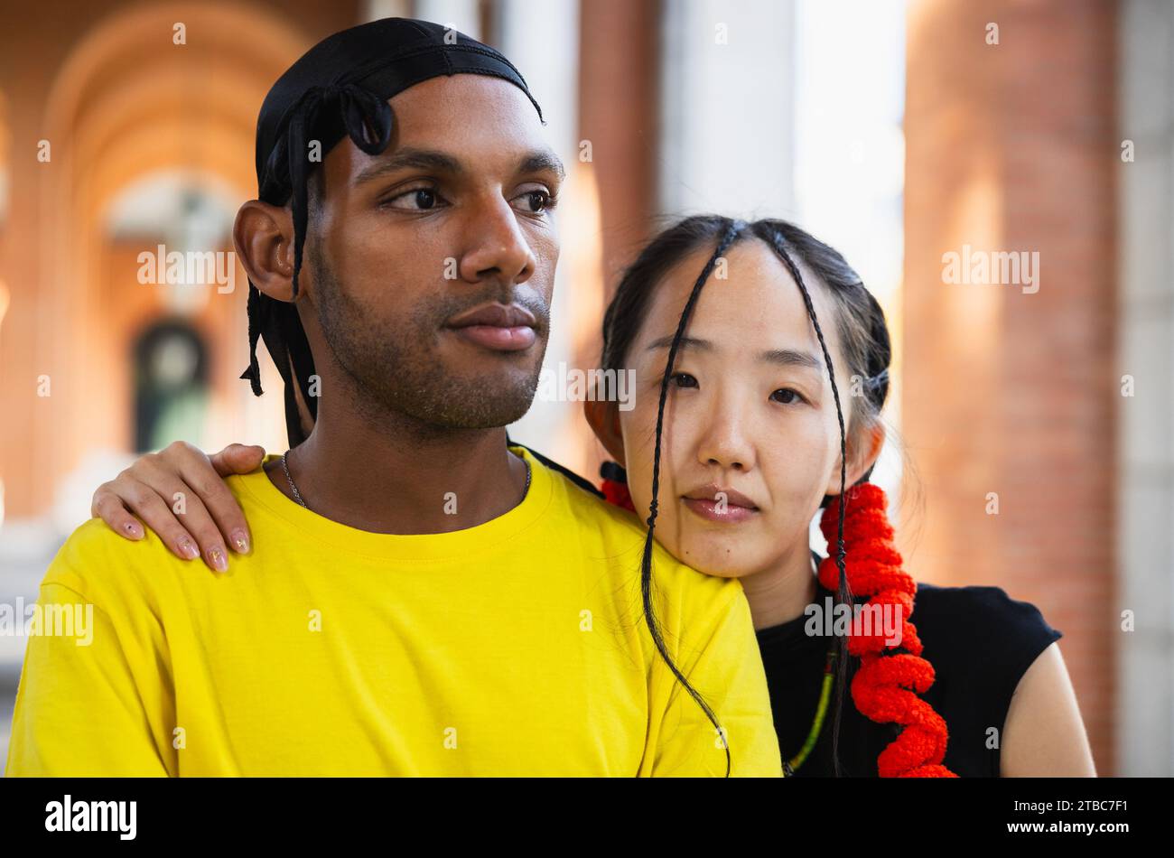 Portrait of multiracial urban dancers couple resting in the street ...