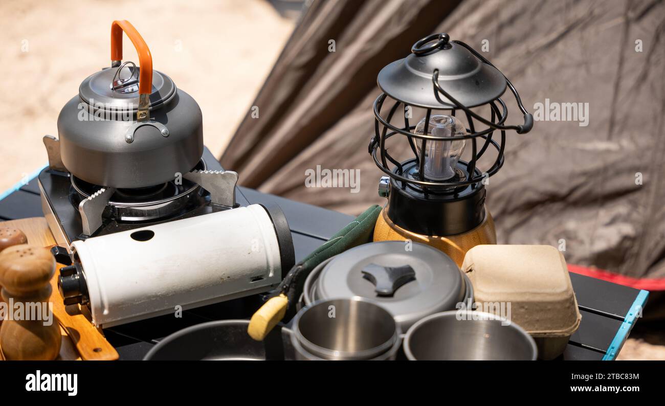 Cooking gear for a tranquil beach campsite, kettle, pot, pan, gas stove ...