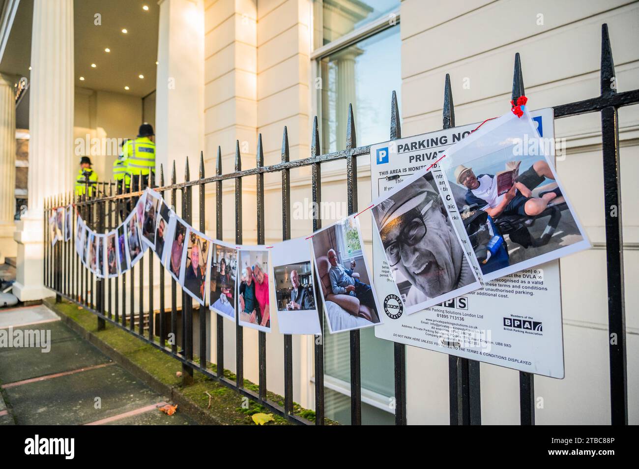 London, UK. 6th Dec, 2023. Pictures of victims are draped on the ...