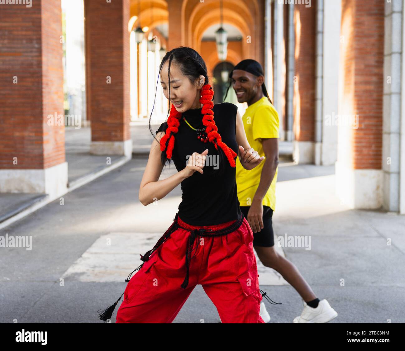 Young modern urban modern dancers in colorful clothes dancing in the ...