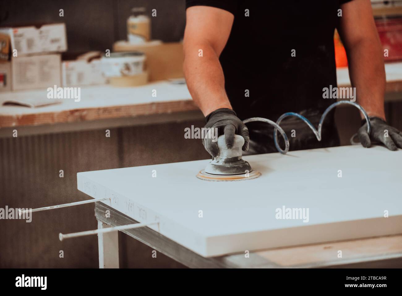 A skilled craftsman in the woodworking industry meticulously operates a ...