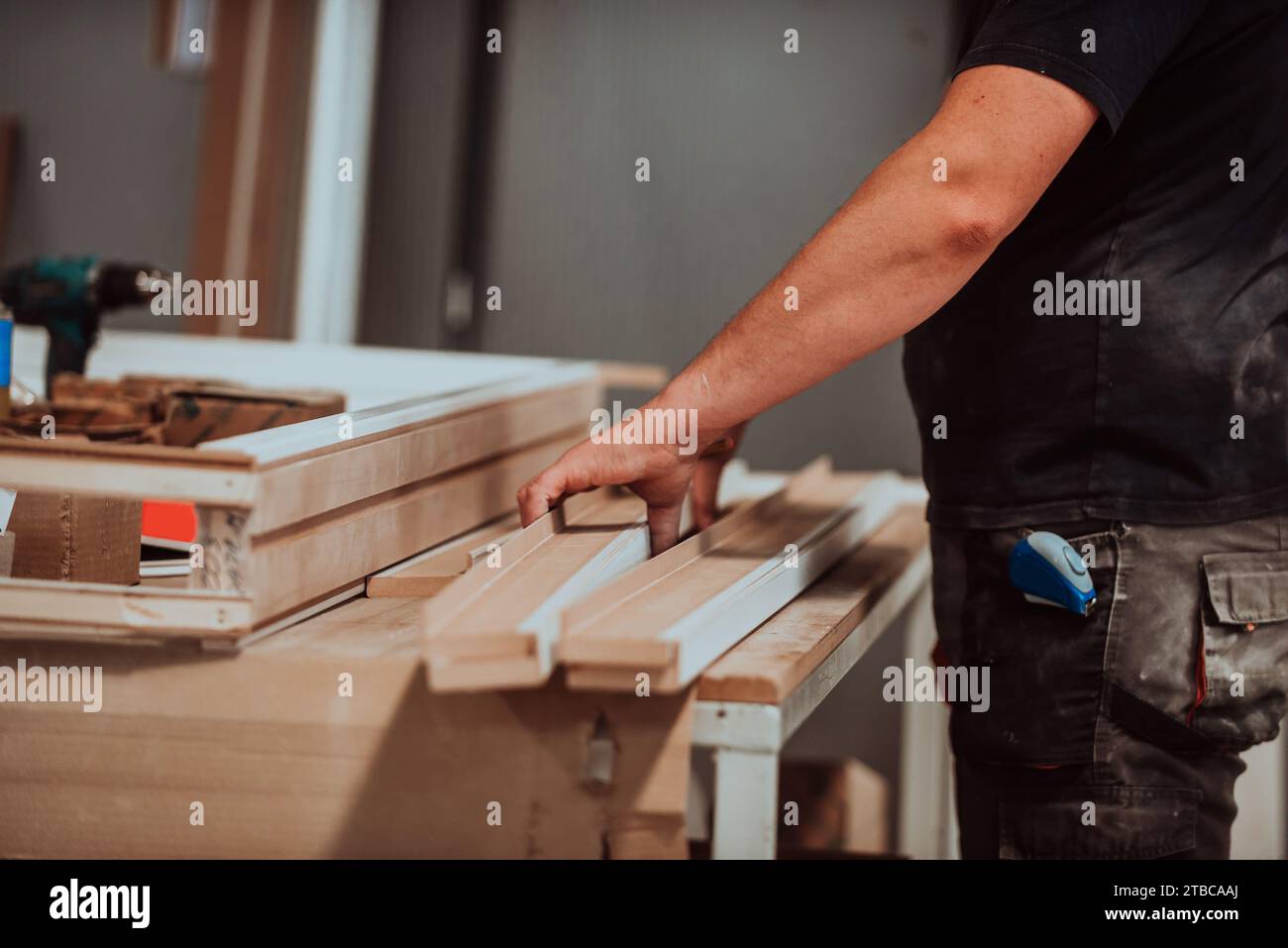 A skilled worker in the woodworking industry adeptly utilizes modern ...