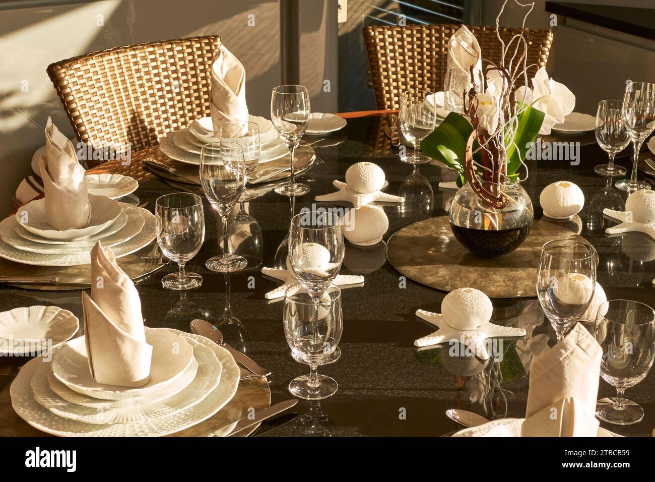 Luxury yacht charter table setting with flowers,wine glasses and marine ...