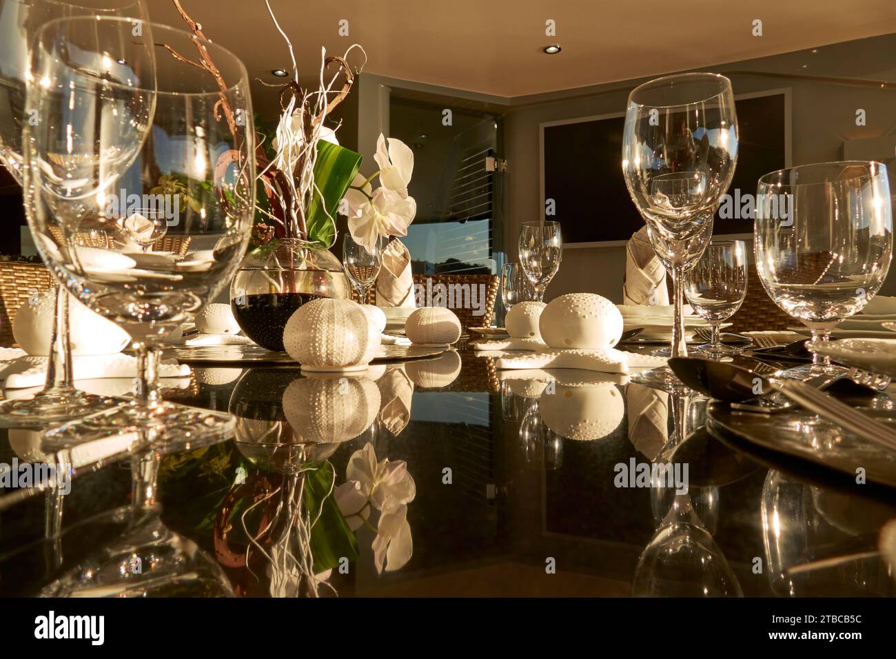 Luxury yacht charter table setting with flowers,wine glasses and marine ...