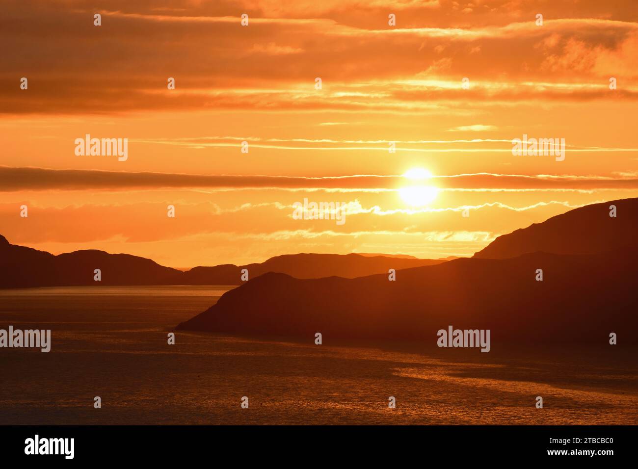 Sun setting in the west of Scotland as Loch a' Chàirn Bhàin and ...