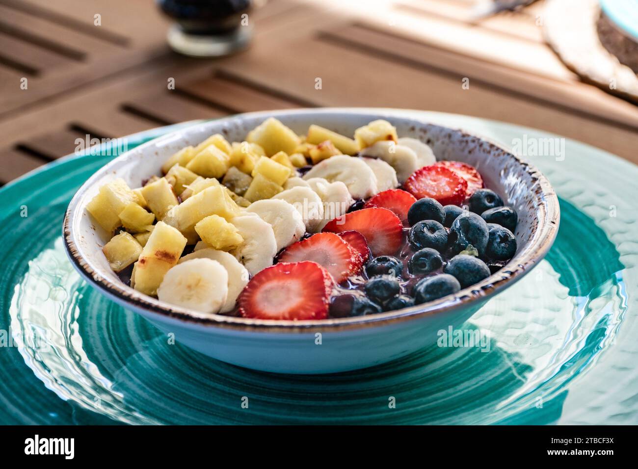 a close up image of a bowl filled with fresh acai ice cream topped with ...