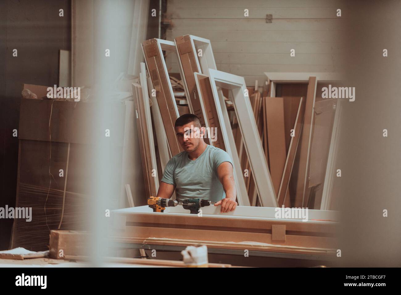 A skilled worker in the woodworking industry adeptly utilizes modern ...