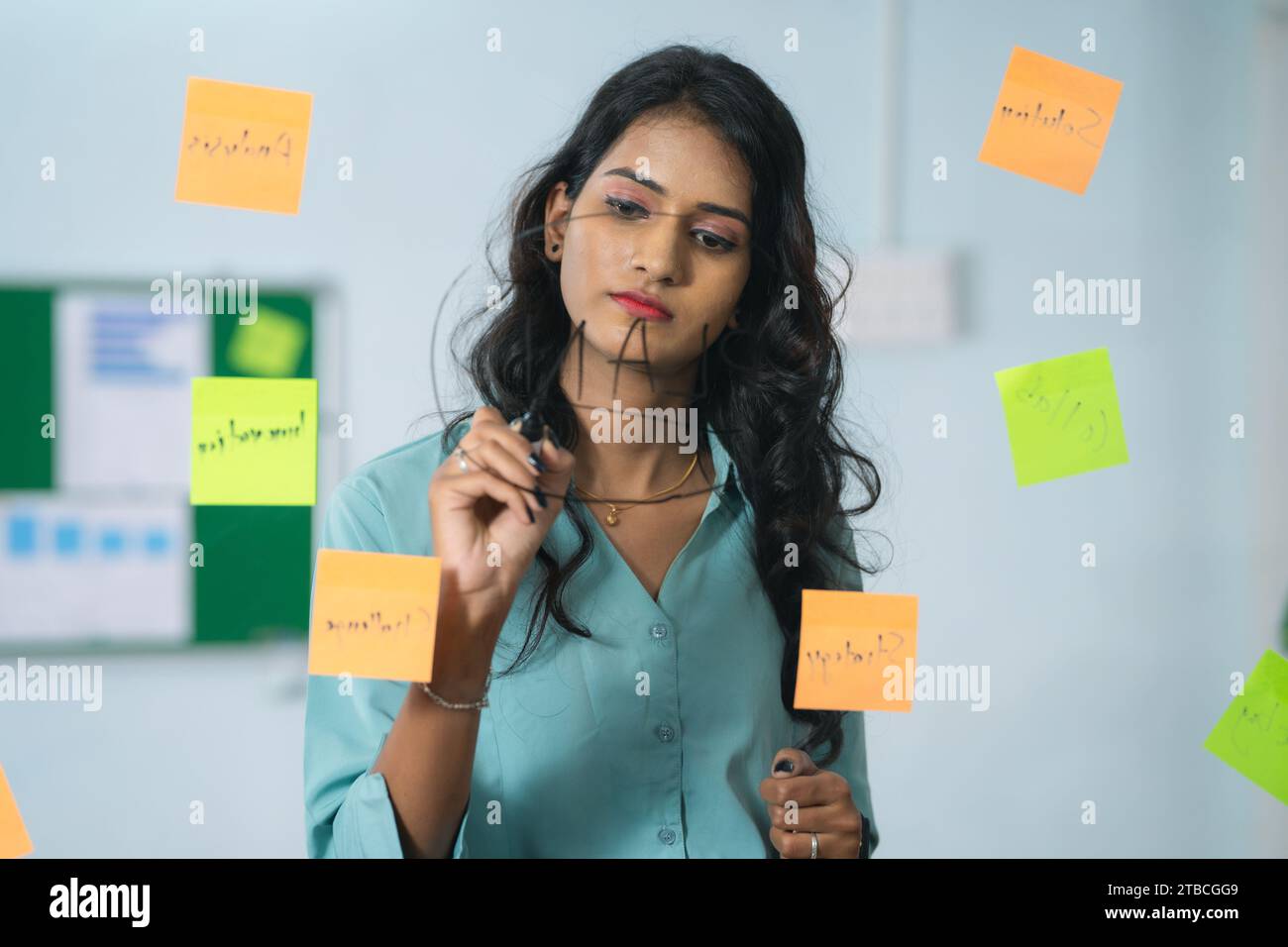 young Indian woman planning at office for project completion or ...