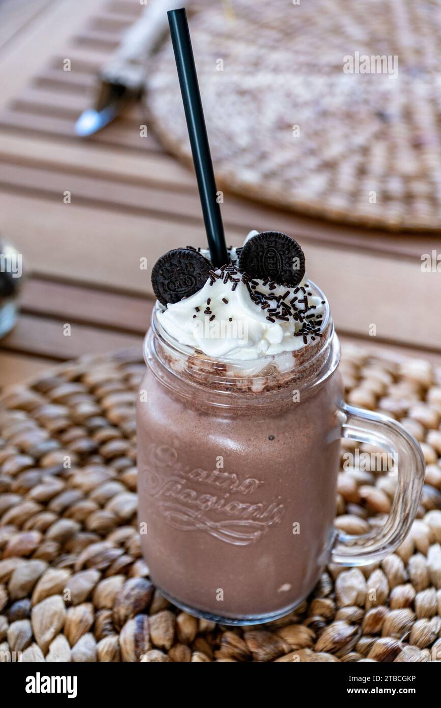 a freshly made chocolate milkshake topped with whipped cream and ...