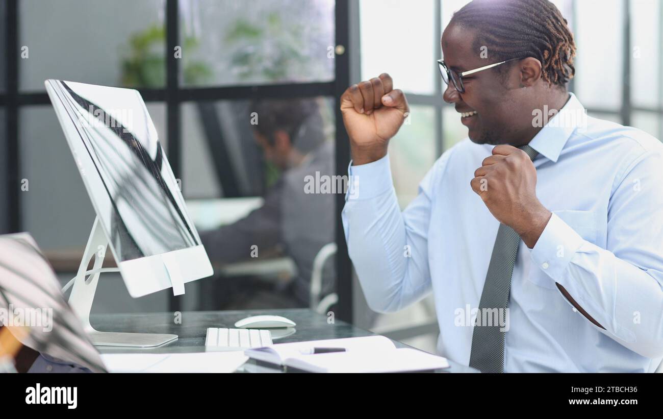 happy man working in the office. raised his hands joyfully Stock Photo ...