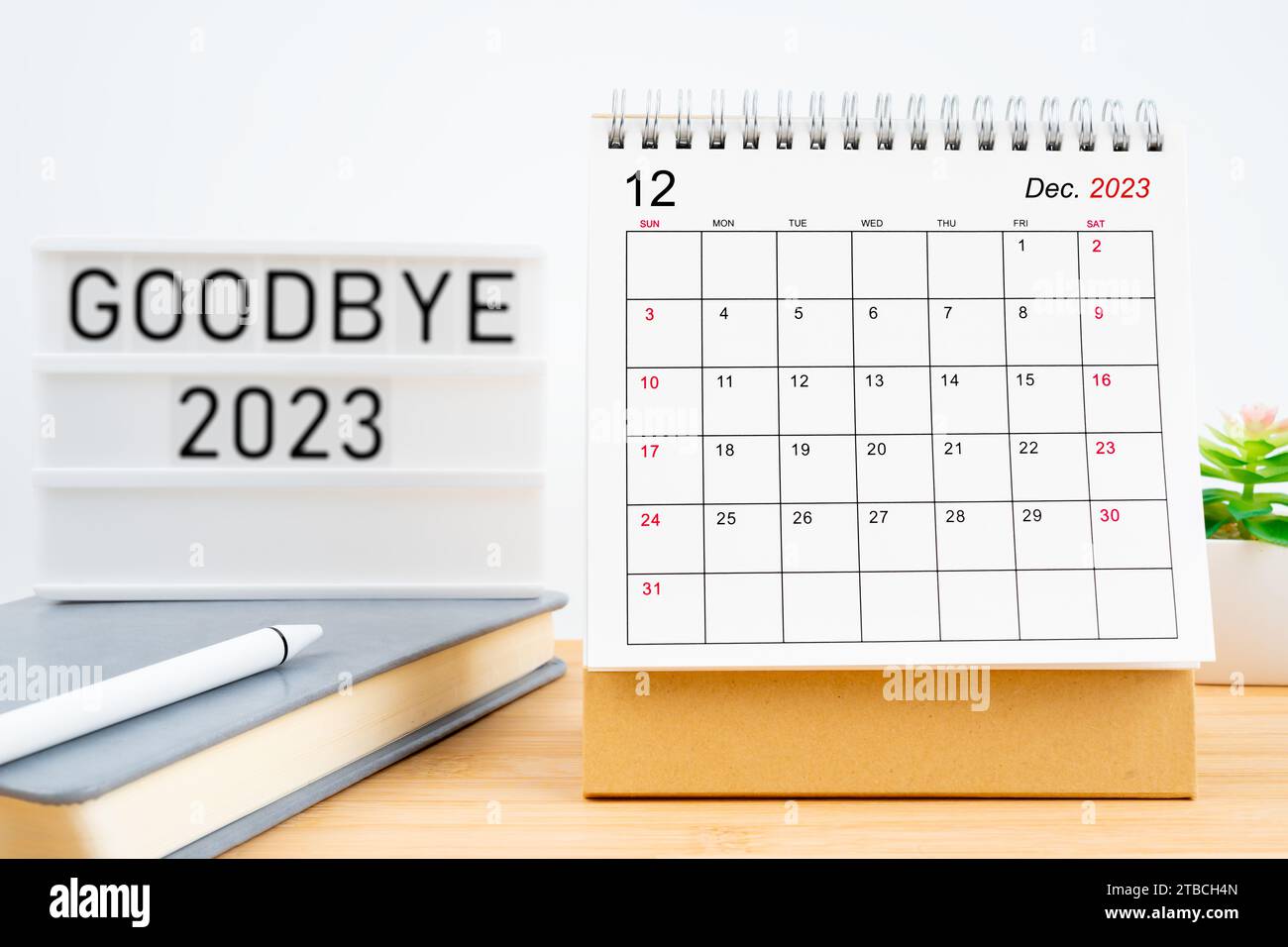 December 2023, Monthly desk calendar and goodbye 2023 text on lightbox ...