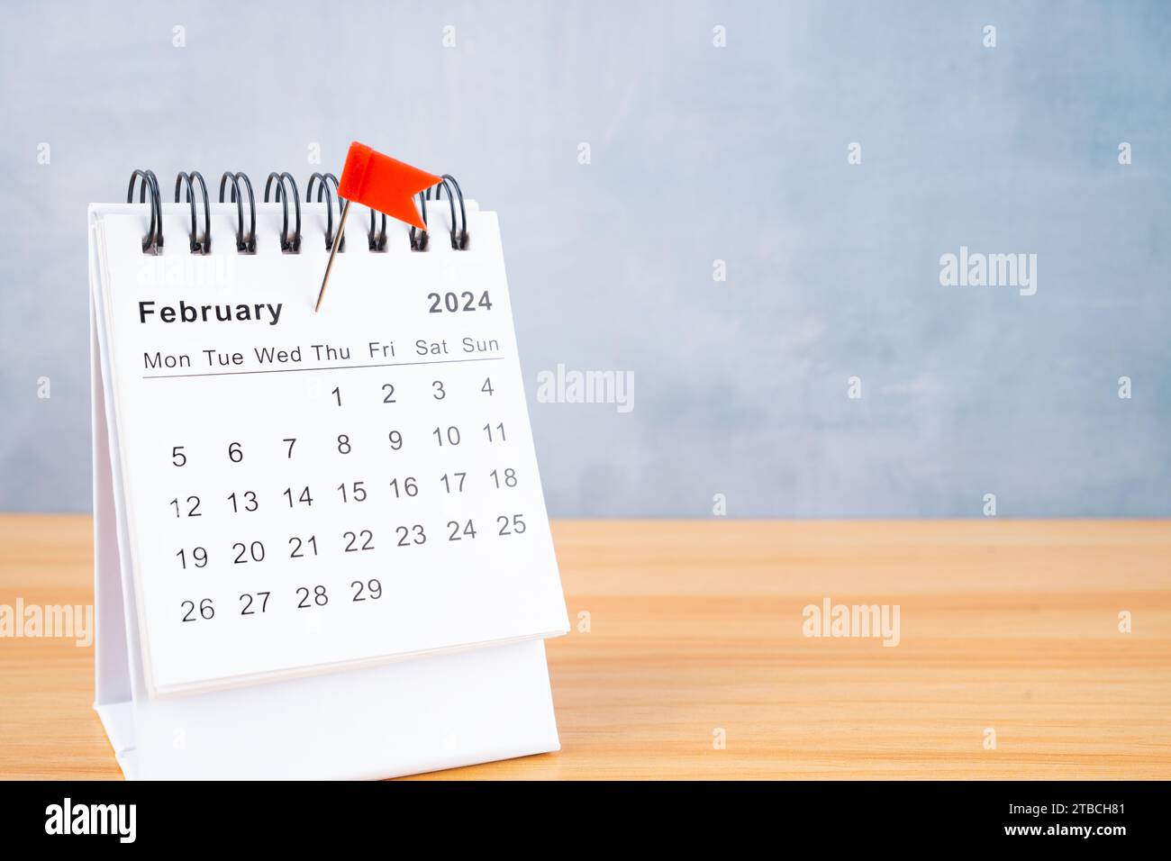 February 2024 calendar and red push pin on wooden table Stock Photo - Alamy