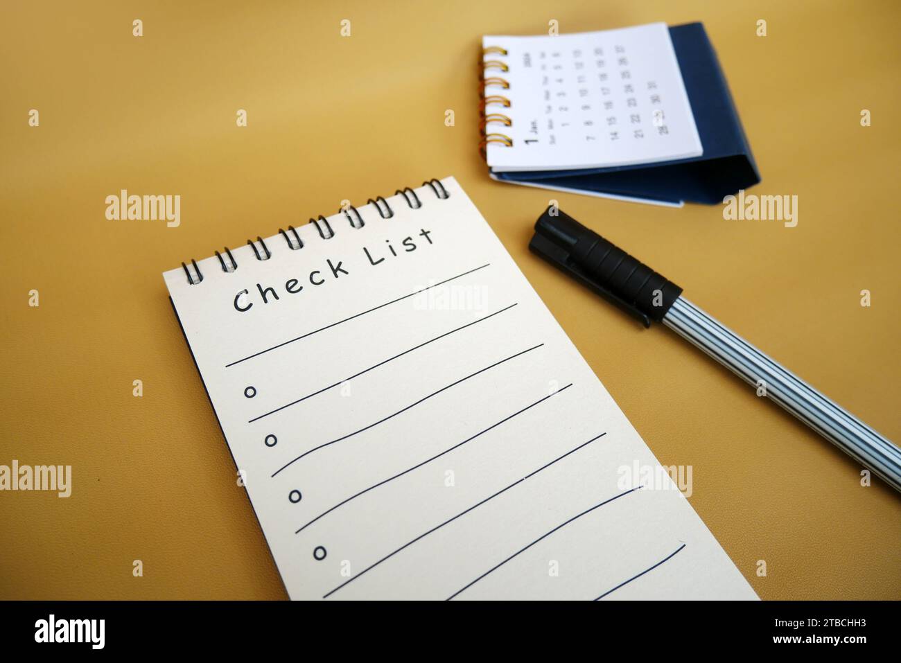 Top view. Checklist book with 2024 calendar and green plant. New Year 2024 goals, resolutions ...