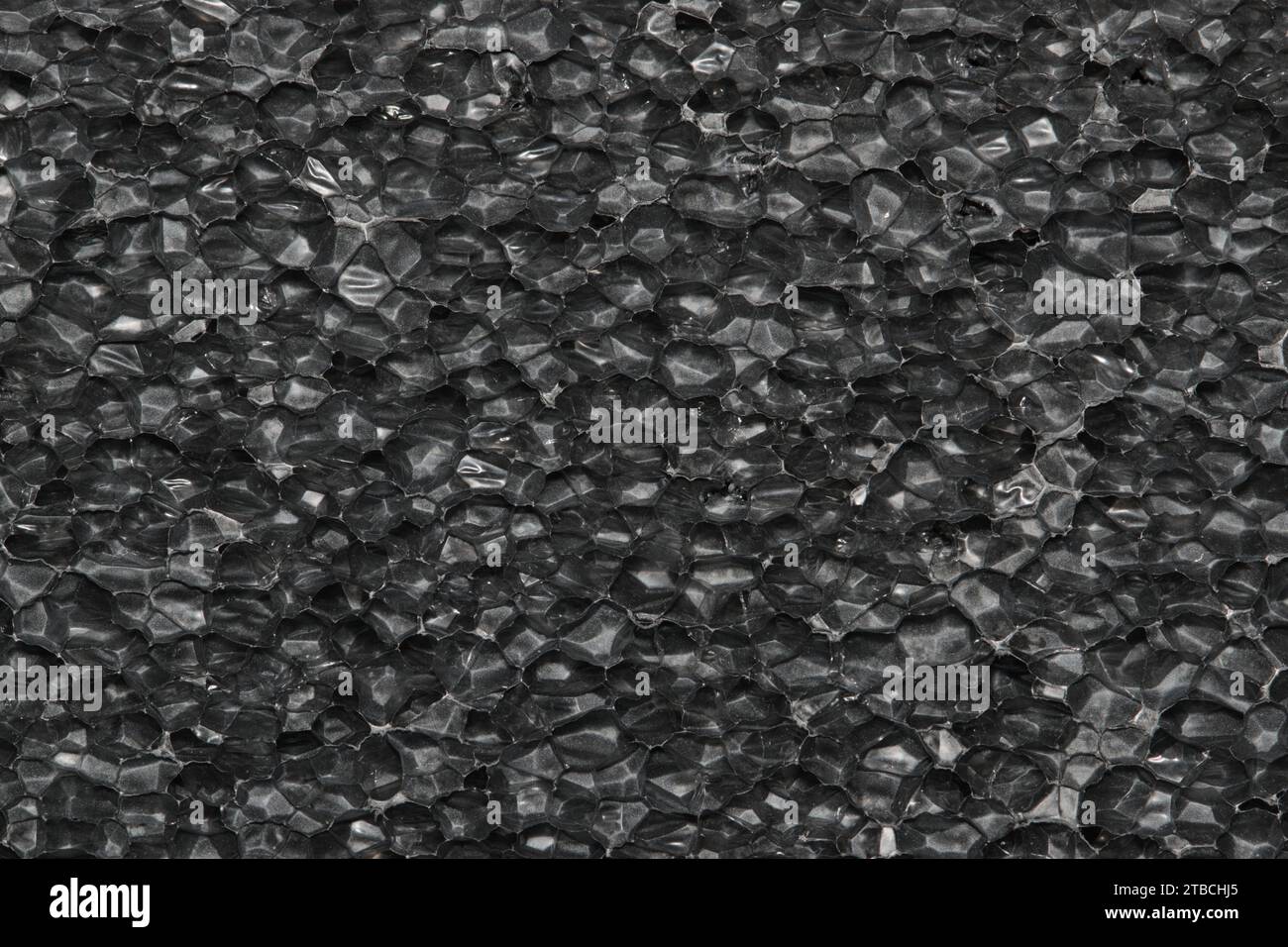 Black Expanded polyethylene foam sample background. EPE beads packing ...
