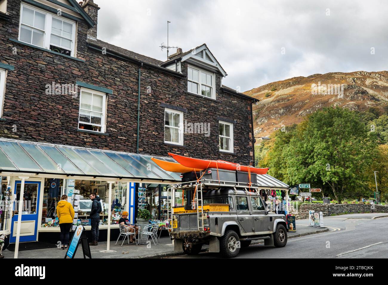 Old Land Rover Defender with canoes or kayaks on top parked oustdie ...